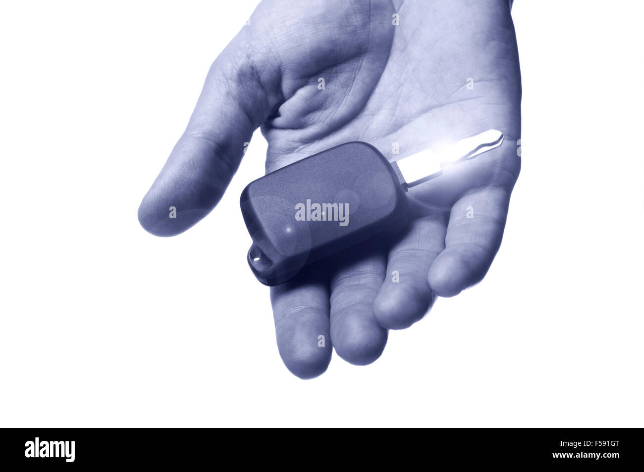 Car key on human hand blue tone easy isolated on white Stock Photo - Alamy