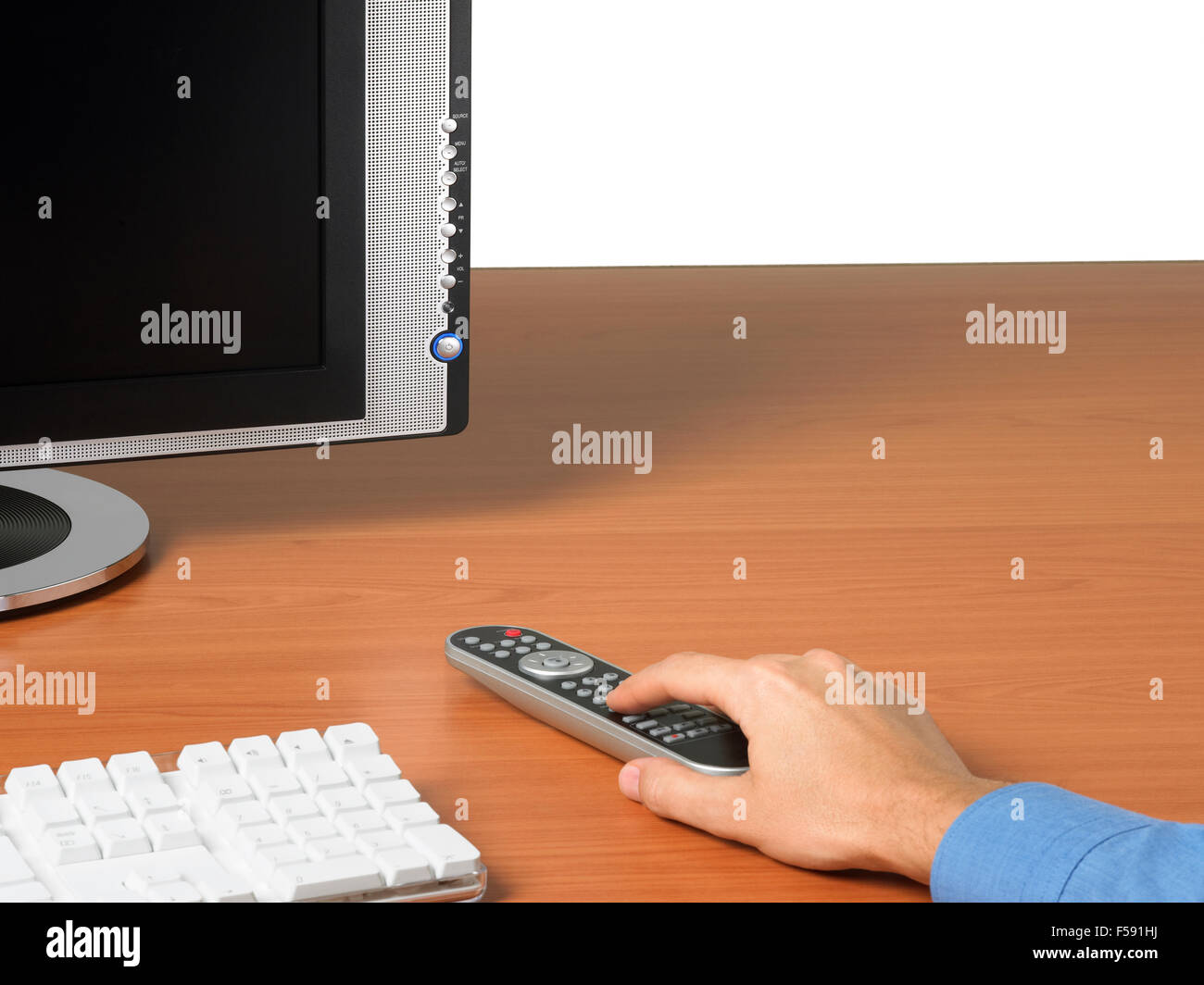 TV monitor, keyboard, hand with remote control and copy space on the ...