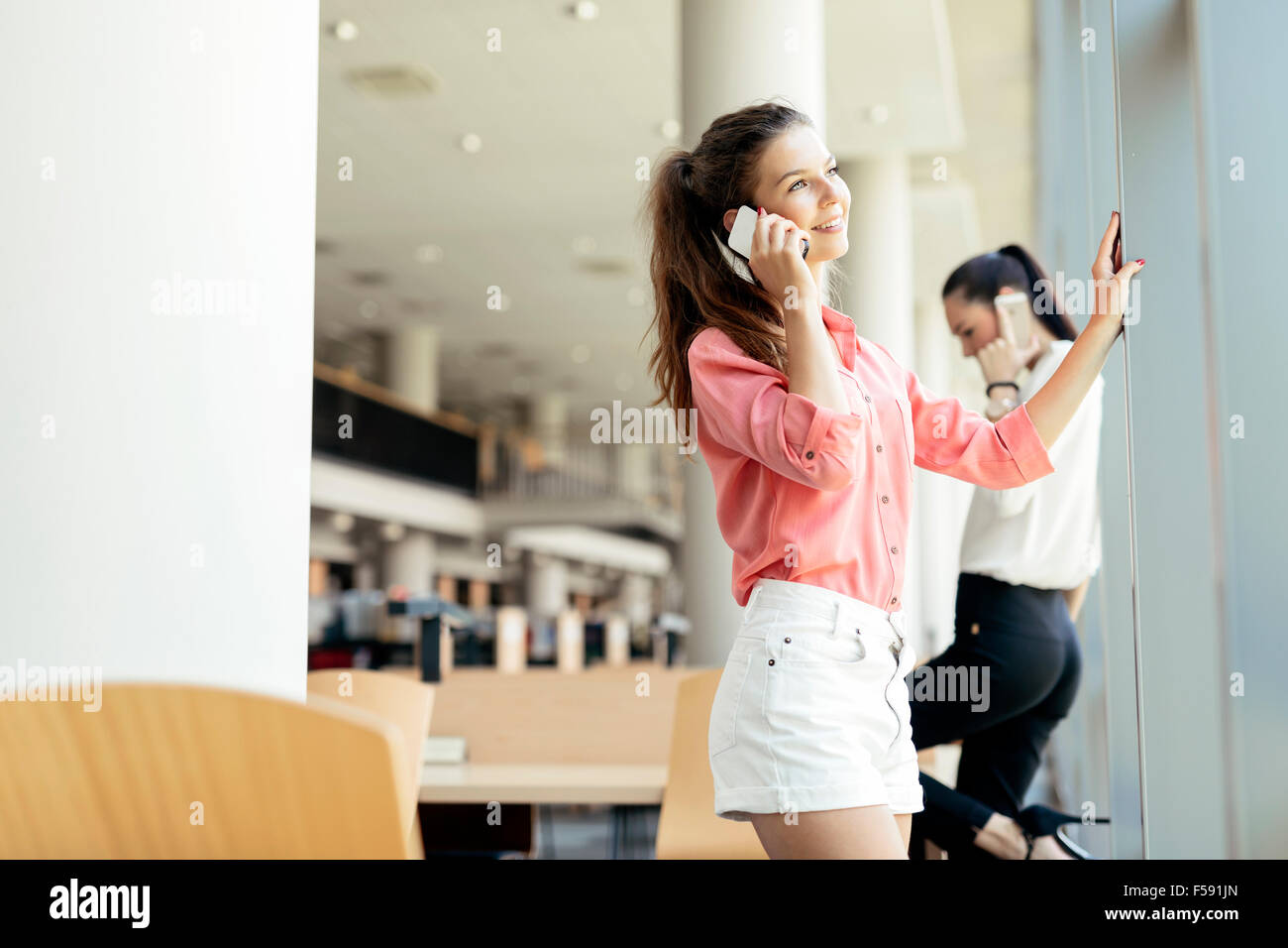 Beautiful women, colleagues using phones and talkin during break Stock ...