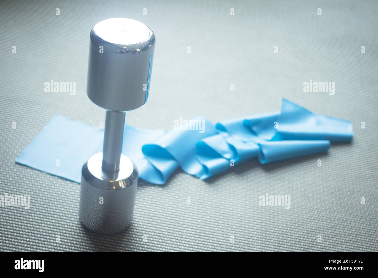 Dumbbell gym metal weights and yoga pilates stretching band in exercise ...