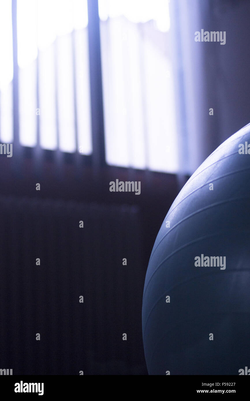 Blue pilates gym aerobics exercise ball in gymnasium Stock Photo - Alamy