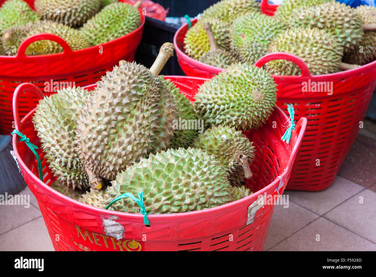 Basket with durian fruit at the street market, Singapore Stock Photo ...