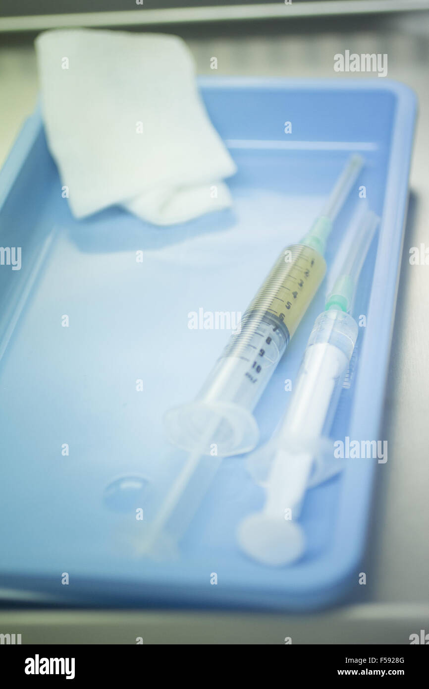 Medical laboratory syringe, sterile swab and tray used for preparation ...
