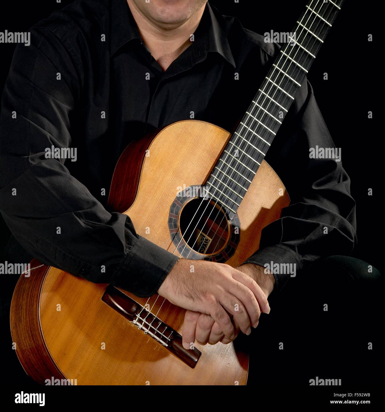 Classical Guitarist low key image square format Unrecognizable person ...