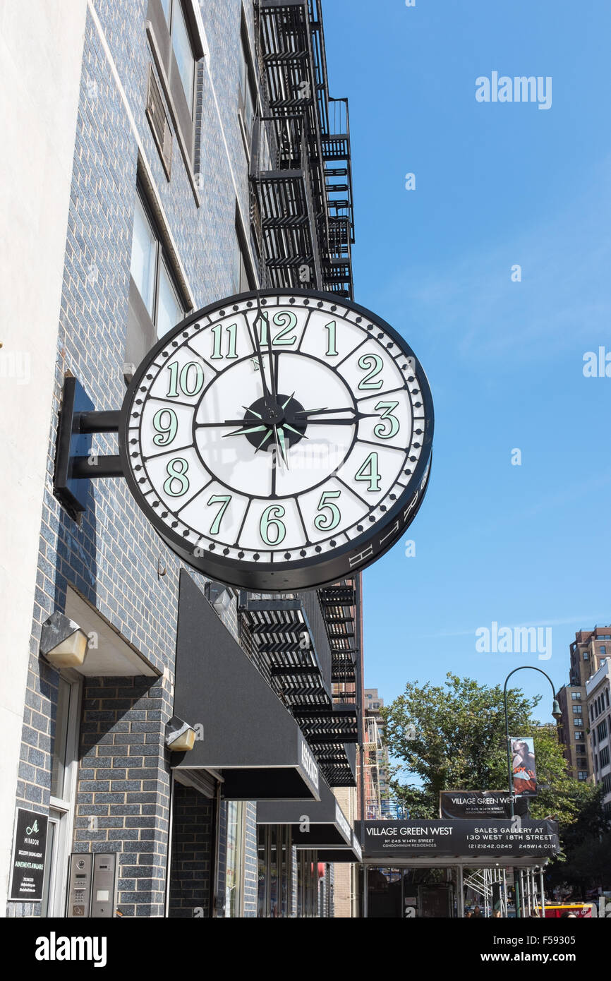 Large clock hanging on the wall outside a shop in Manhattan, New York ...