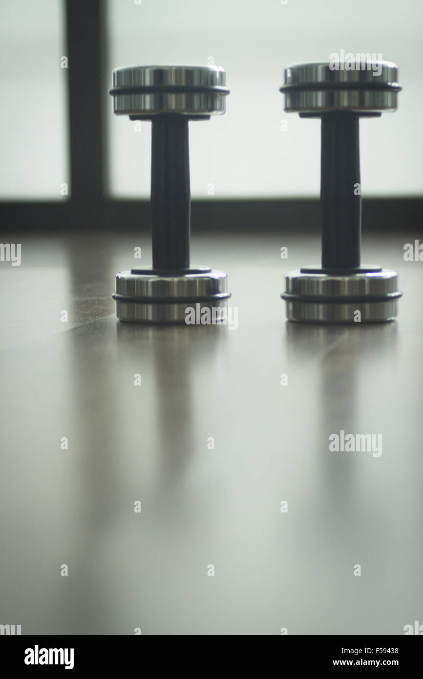 Dumbbell gym metal weights on wooden floor in exercise room in gym ...