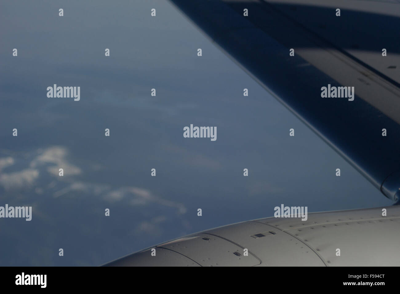 Airplane flying in sky over land in flight engine wing Stock Photo - Alamy