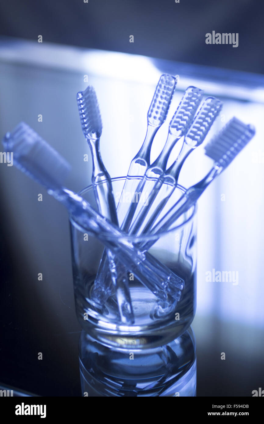 Toothbrushes in glass on glass table dental hygiene plaque control in ...