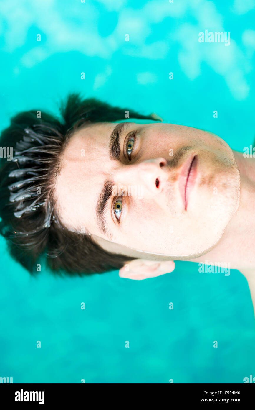 Portrait of a handsome man floating on the water surface Stock Photo ...