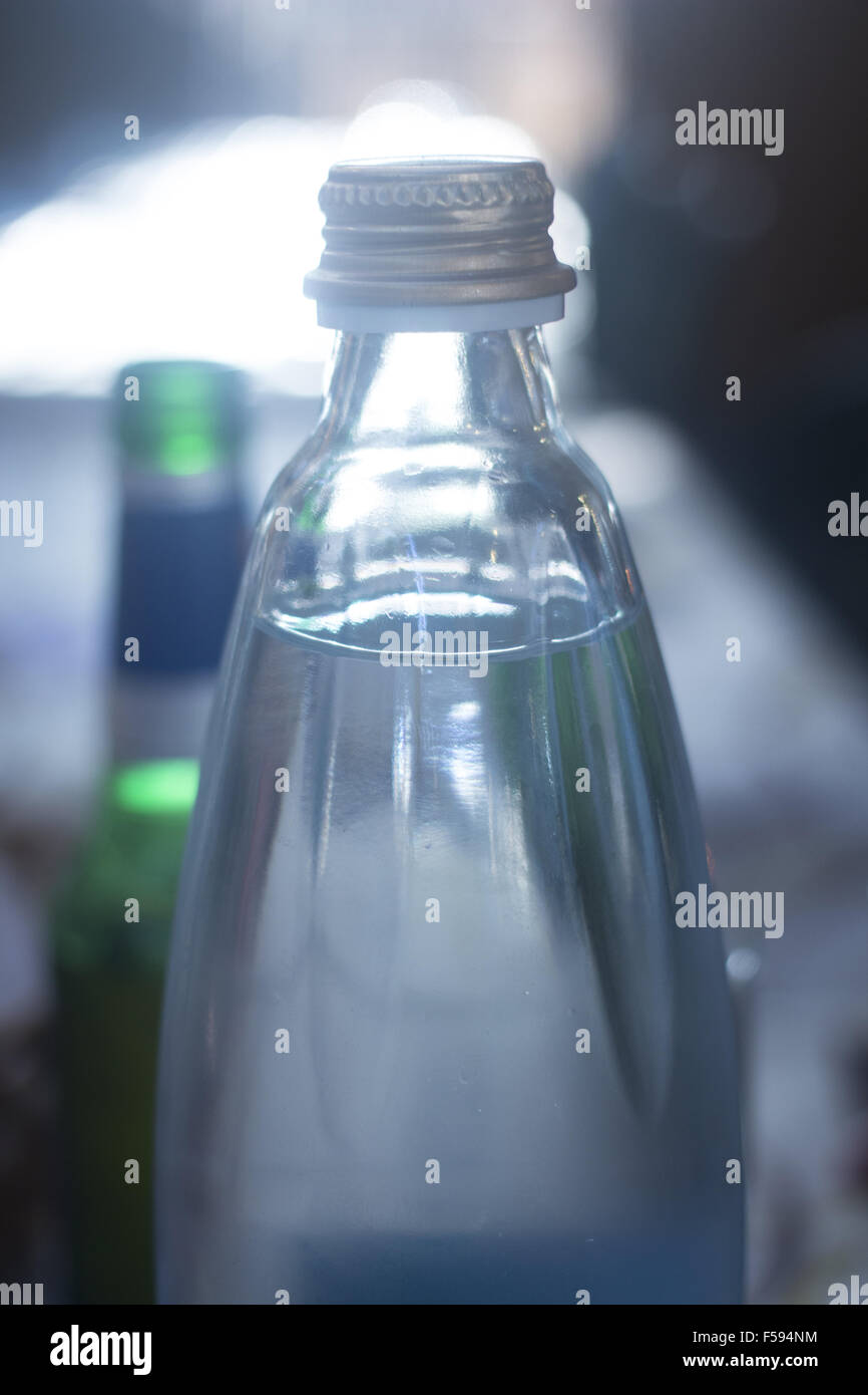 Glass sparkling fizzy water bottle closeup color photo in restaurant ...