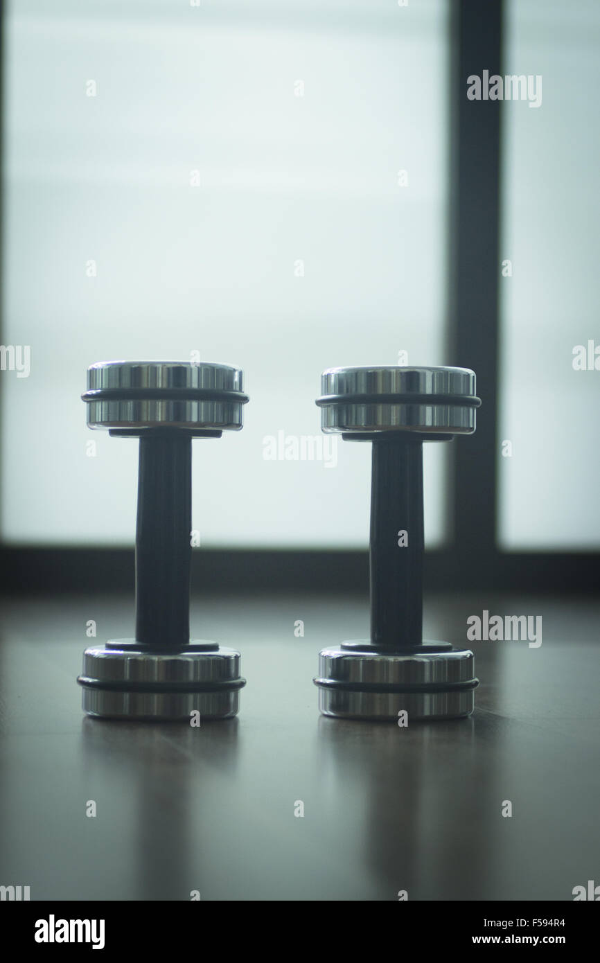 Dumbbell gym metal weights on wooden floor in exercise room in gym ...