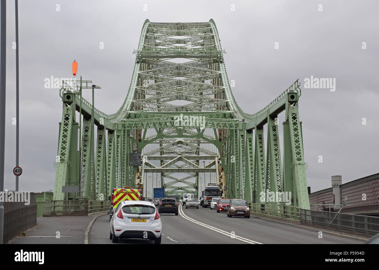Traffic crossing the Silver Jubilee bridge over the River Mersey in ...