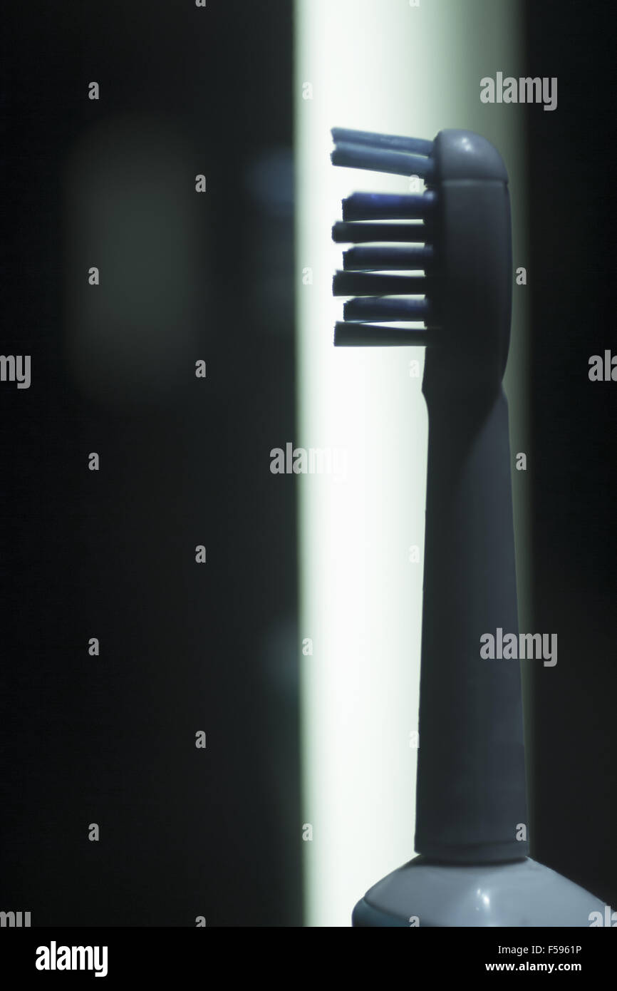 Toothbrush closeup silhouette in artistic light color photo with copy ...