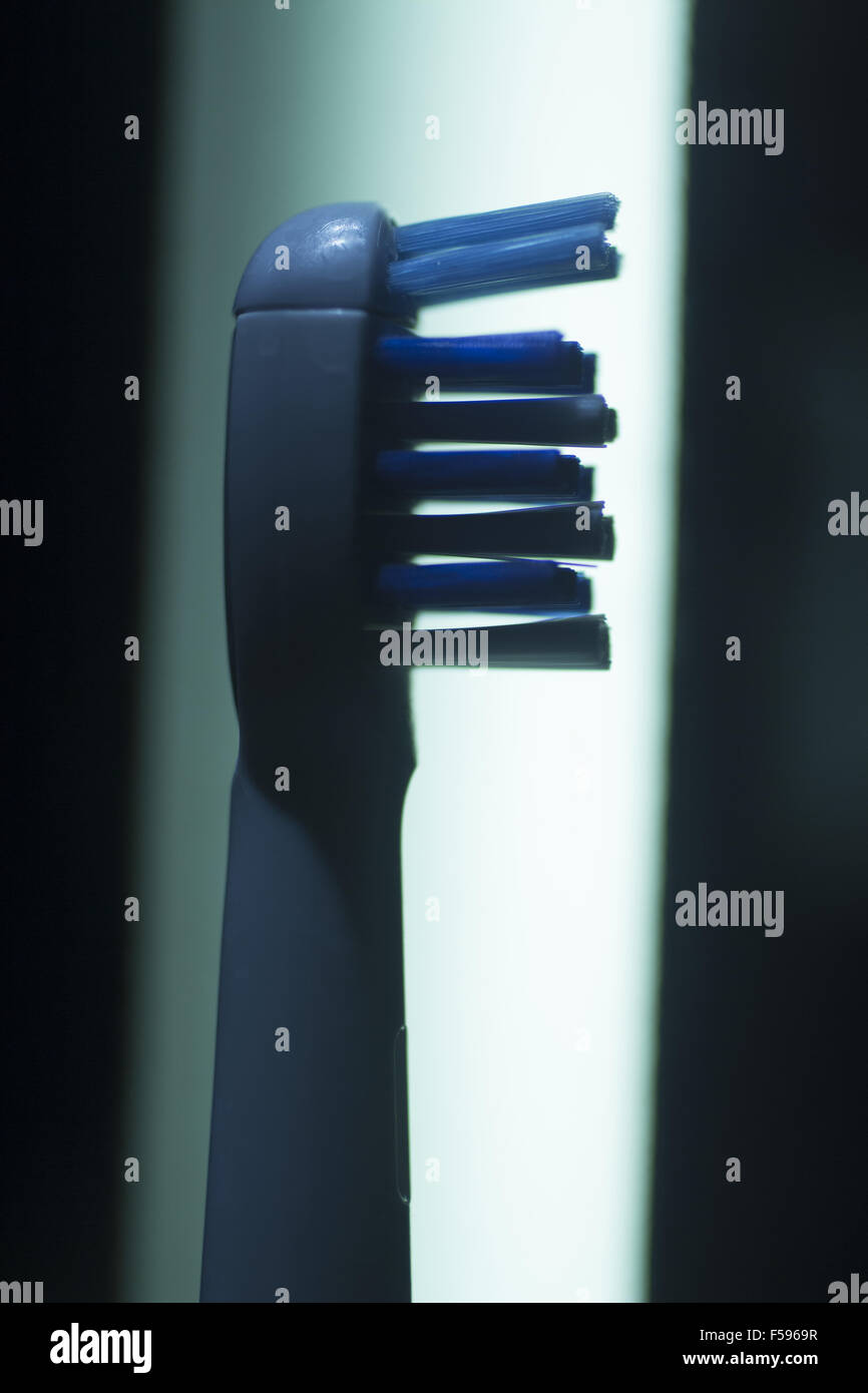 Toothbrush closeup silhouette in artistic light color photo with copy ...