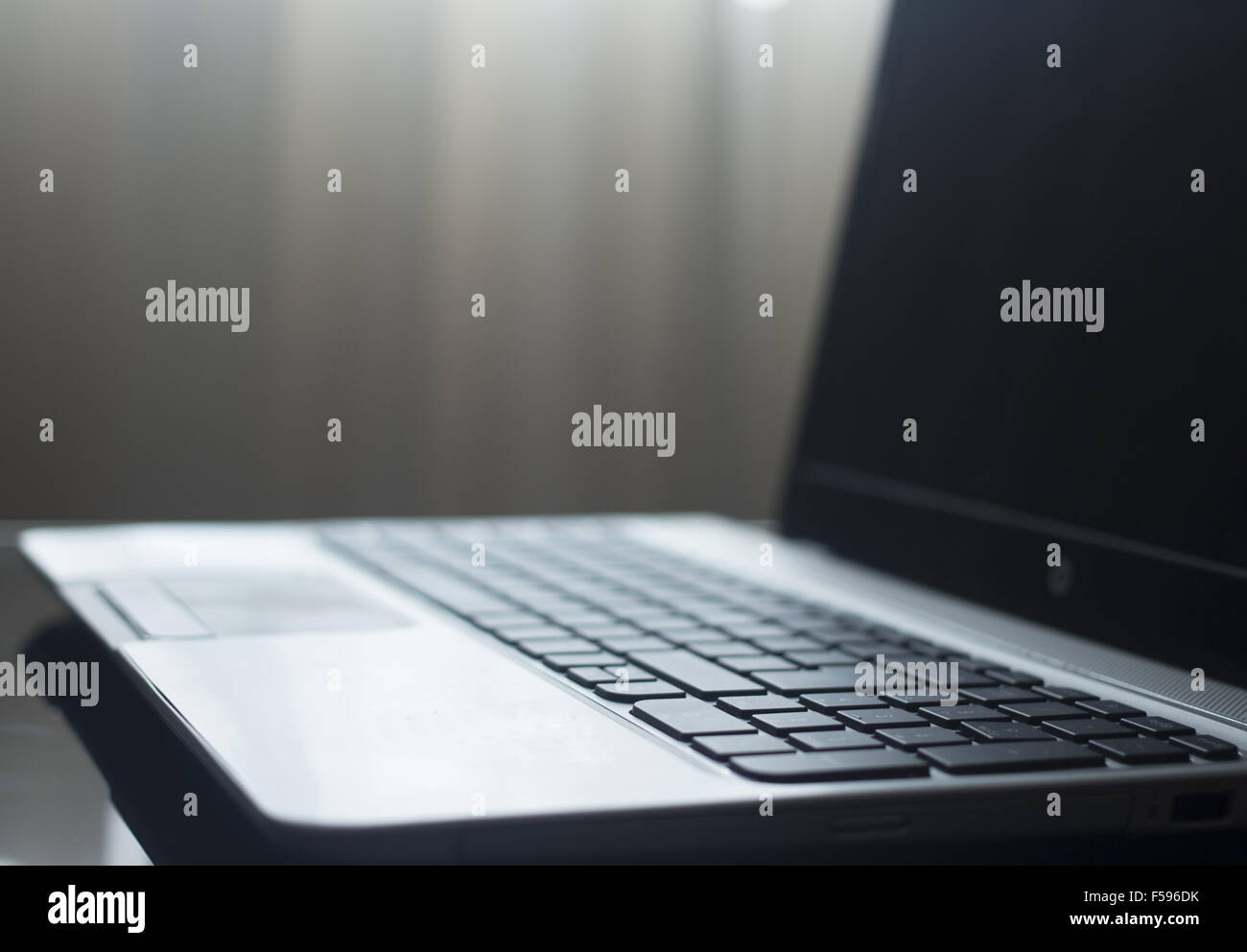 Laptop PC portable notebook computer keyboard screen on glass cofee table artistic photo Stock ...