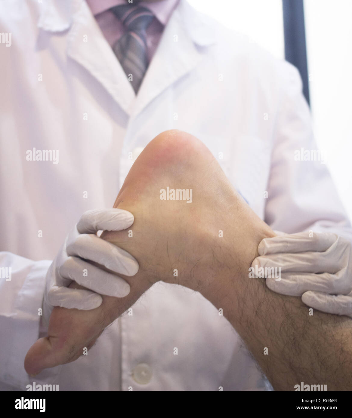 Male Traumatologist orthopedics surgeon doctor examining middle aged ...