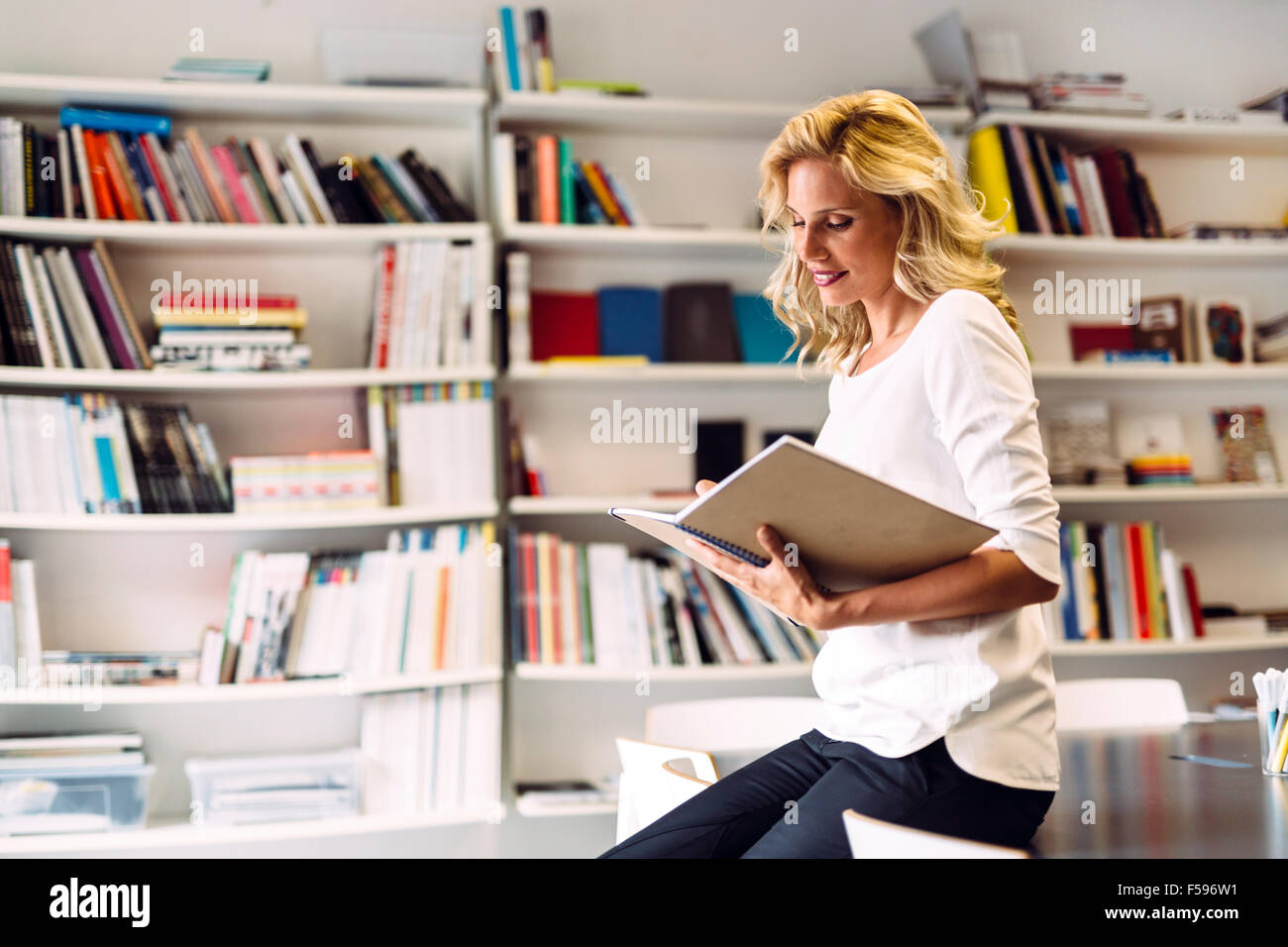 Stunning woman reading a book Stock Photo - Alamy