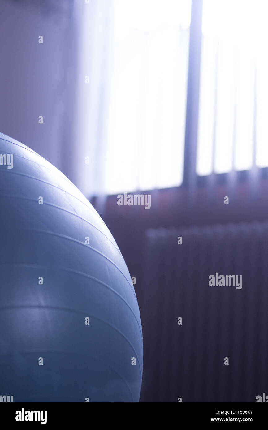 Blue pilates gym aerobics exercise ball in gymnasium Stock Photo - Alamy