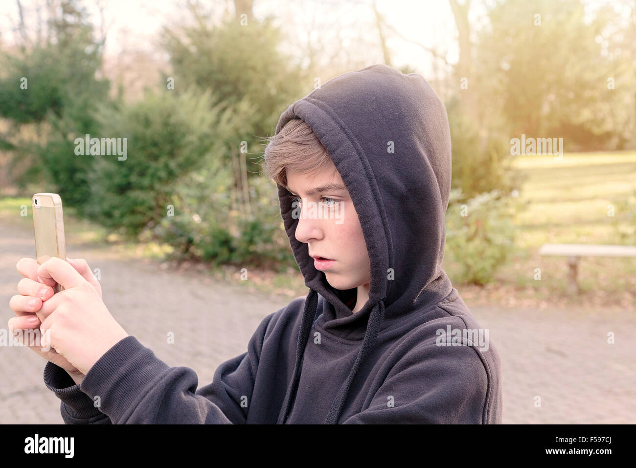 teenage boy taking photographs with a smart phone Stock Photo - Alamy