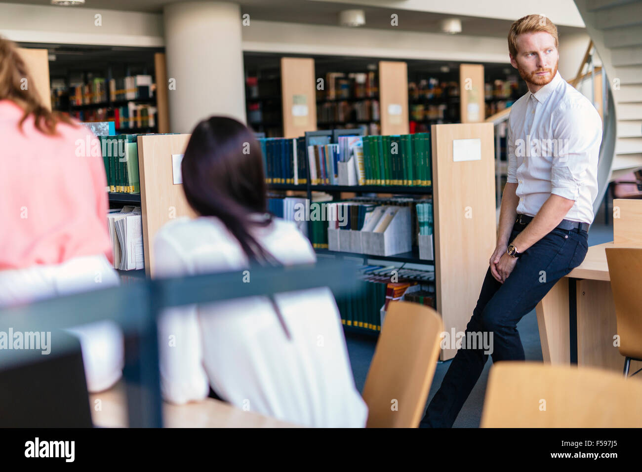 Group of smart young people educating themselves in a library Stock ...