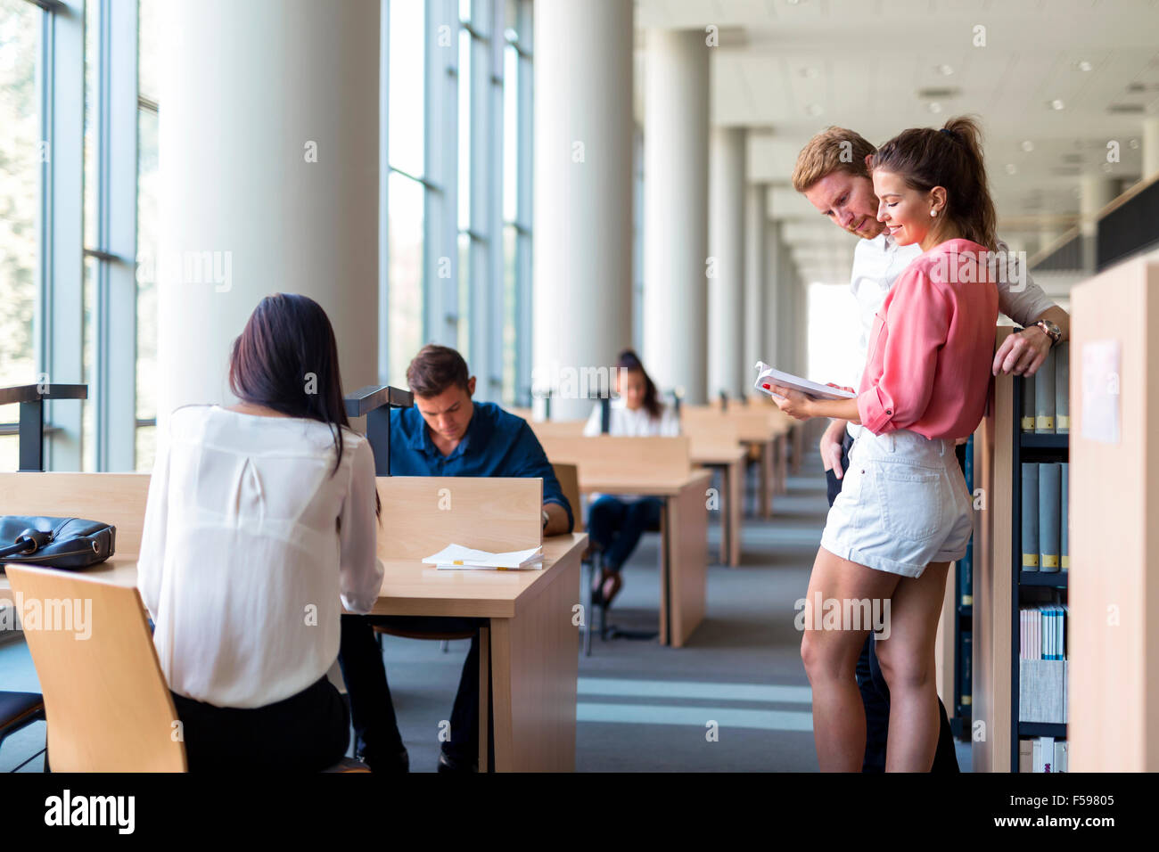 Young students studying together in a library Stock Photo - Alamy