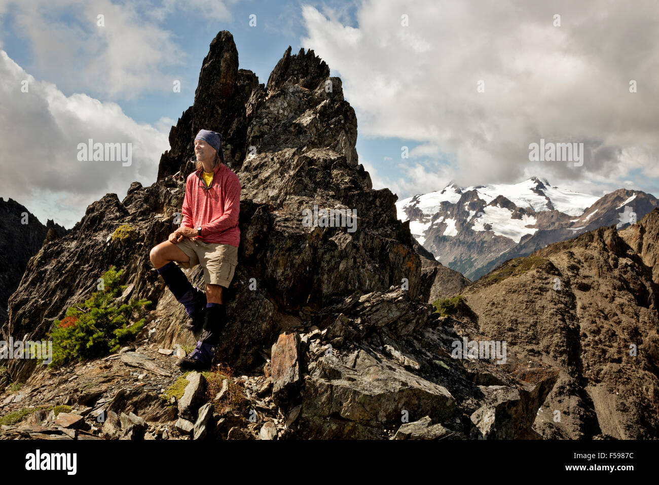 WASHINGTON - Hiker on the summit of Mount Ferry with Mount Olympus in ...