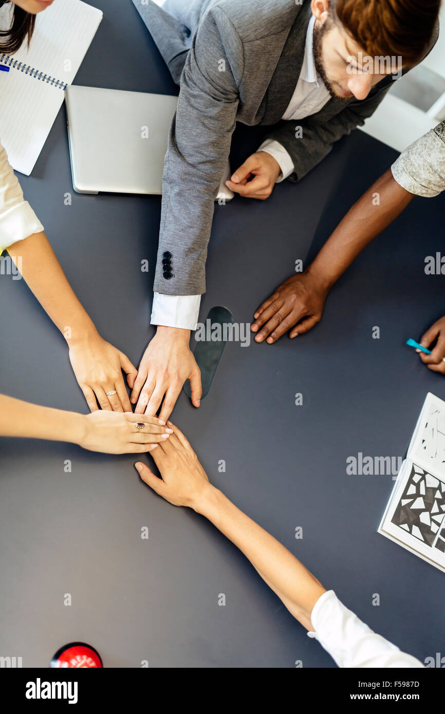 Dedication and teamwork lead to success - colleagues putting their ...