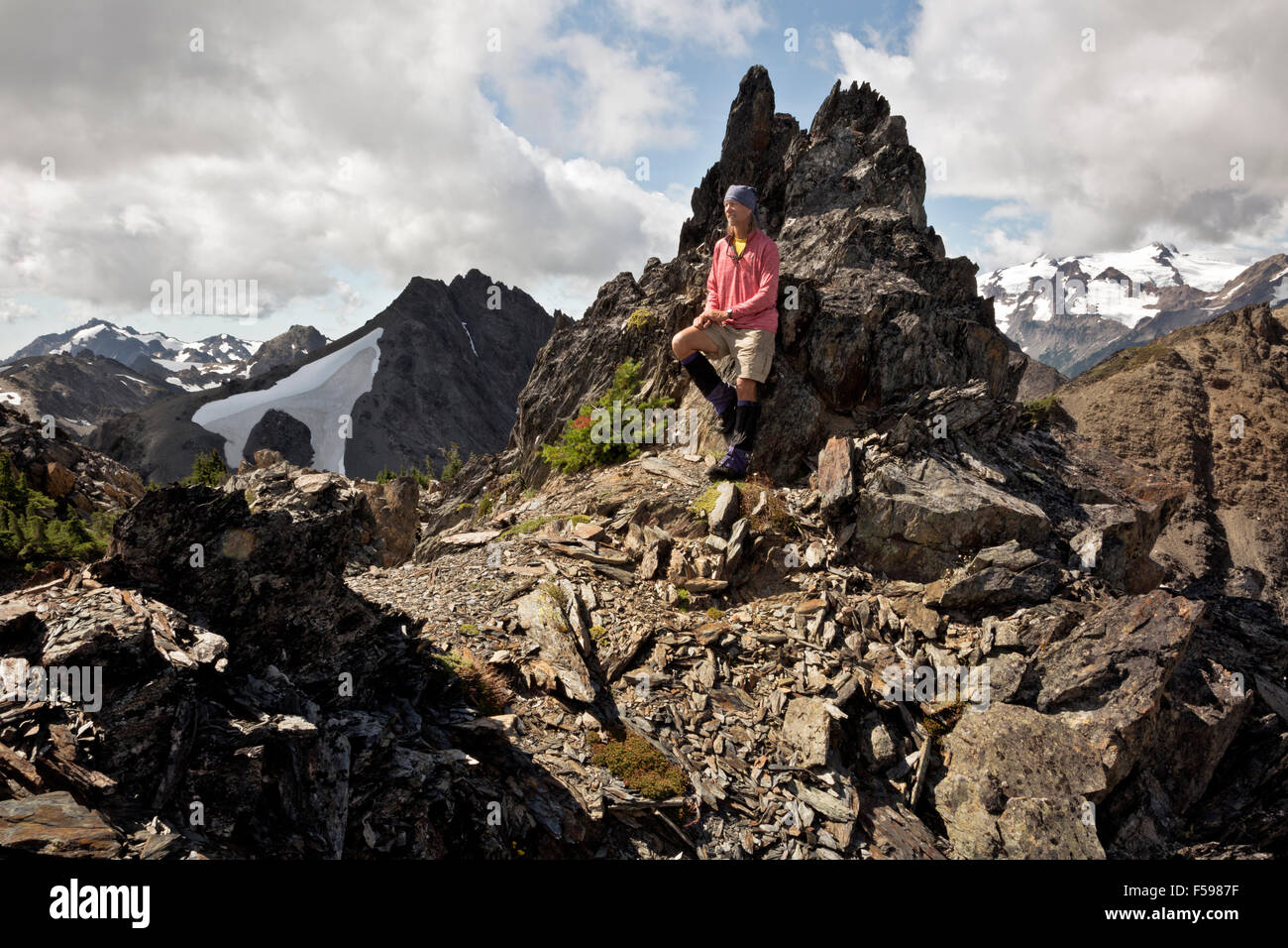 WASHINGTON - Hiker on the summit of Mount Ferry with Mount Olympus in ...
