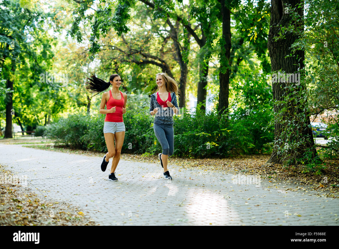 Young fit women jogging outdoors and staying fit Stock Photo - Alamy