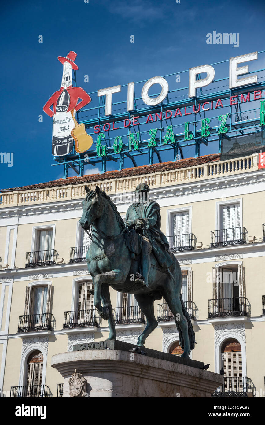 The famous Tio Pepe advertising sign looms over a statue of King Carlos ...