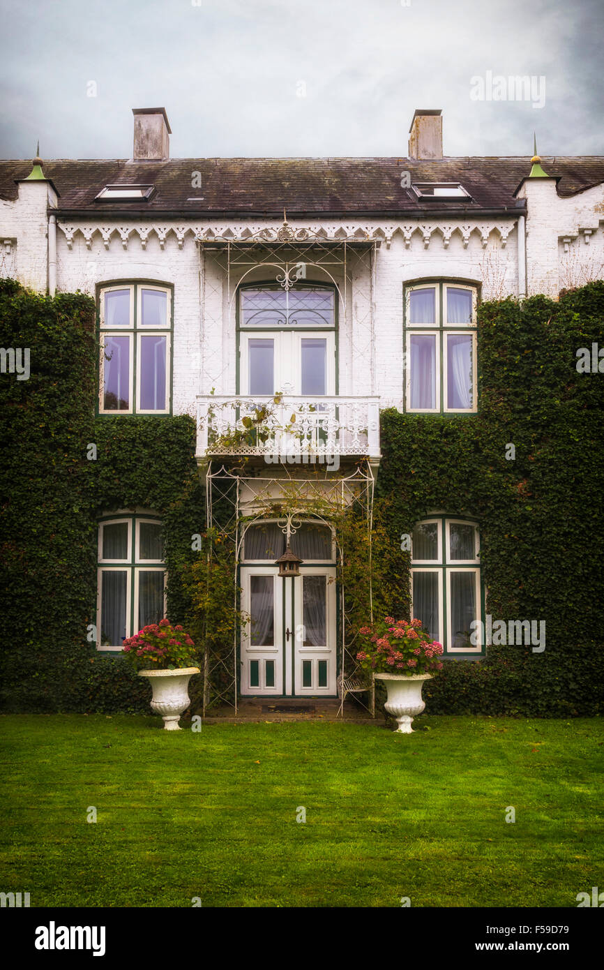 a white manor with flower pots Stock Photo - Alamy