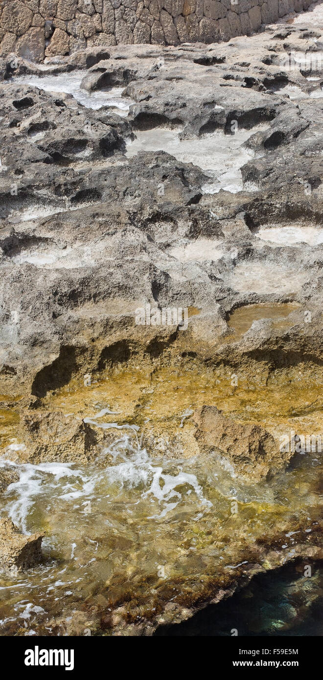 Eroded limestone rock in different shades from built drystone wall down ...