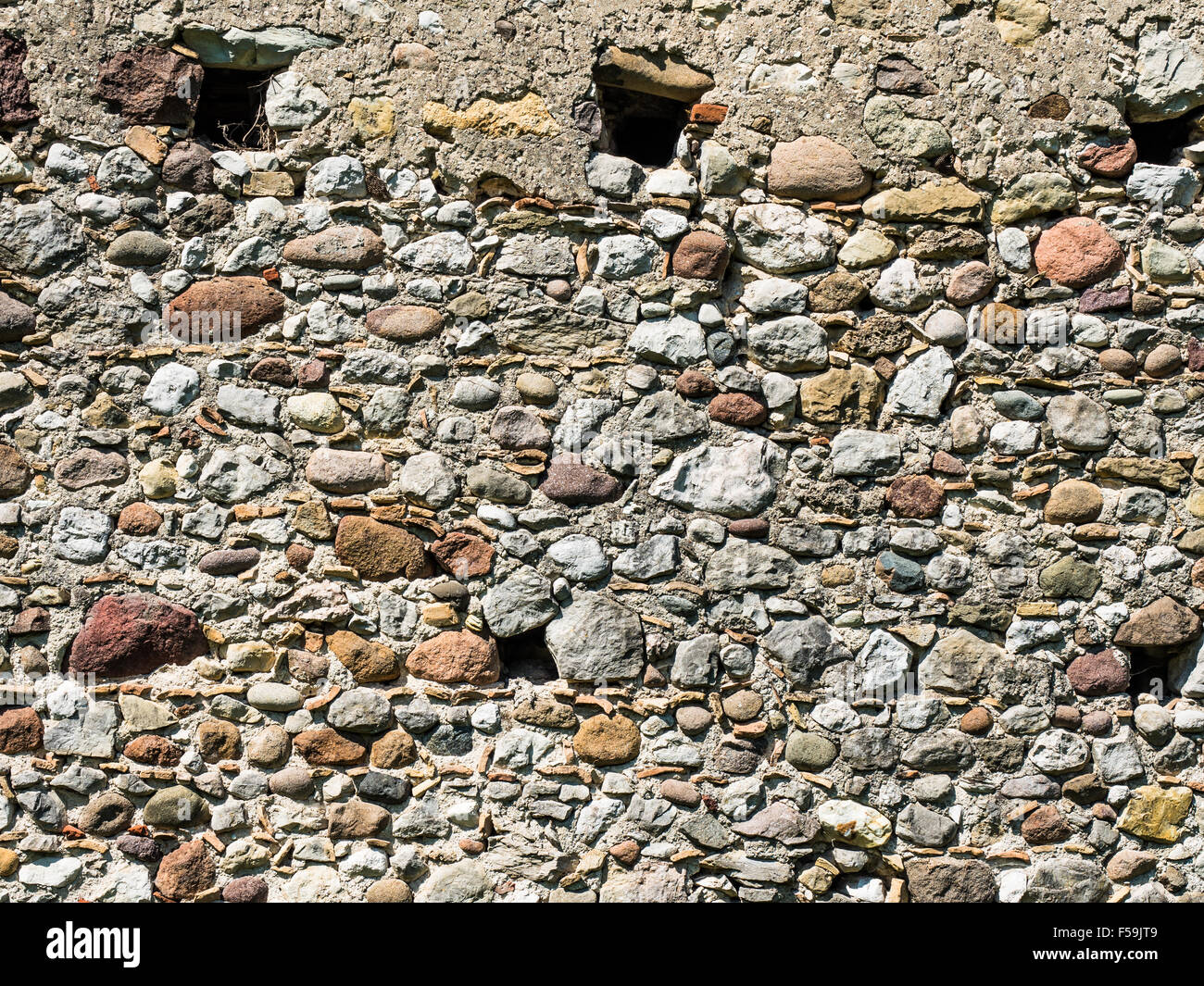 ancient colored wall made of stone and brick Stock Photo - Alamy