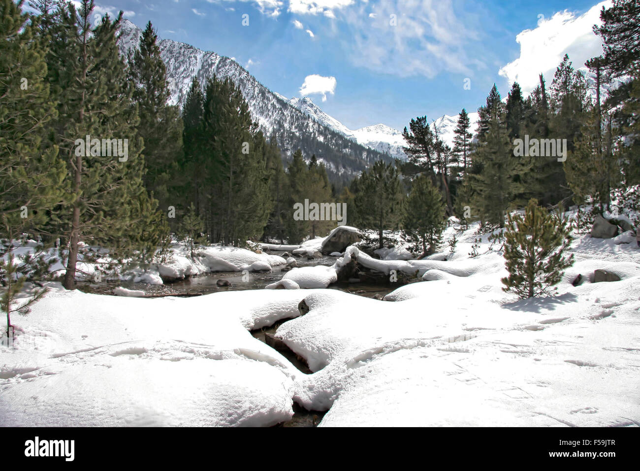 Snowy river landscape in a route of trekking by Aigüestortes i Estany ...