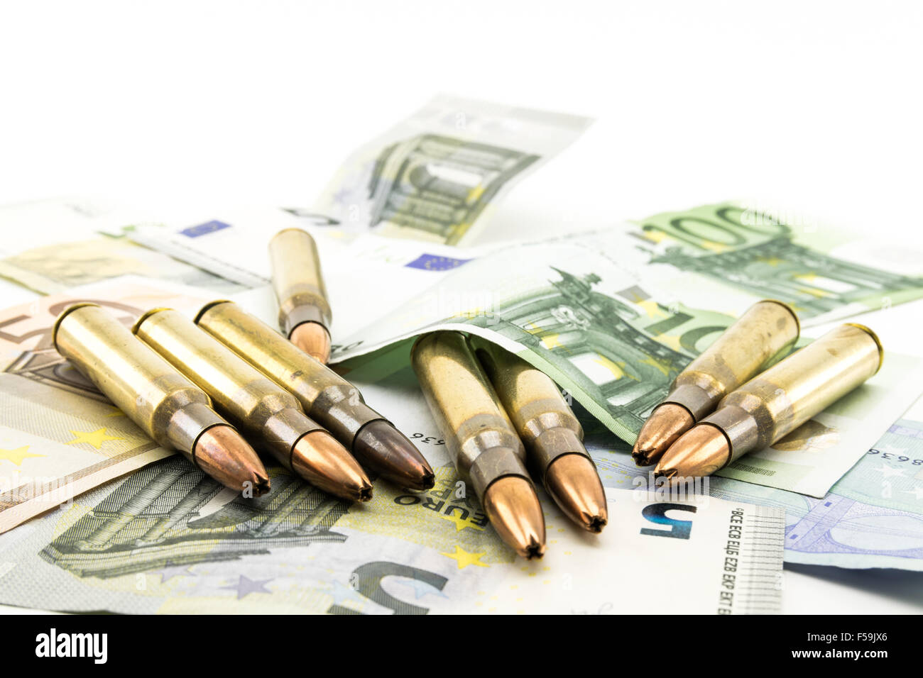 Composition with golden bullets and colorful banknotes Stock Photo - Alamy