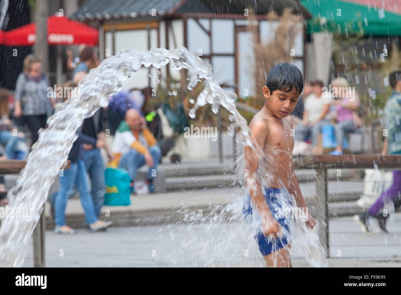 Young Asian Boy Splashing in Fountain Water Stock Photo - Alamy