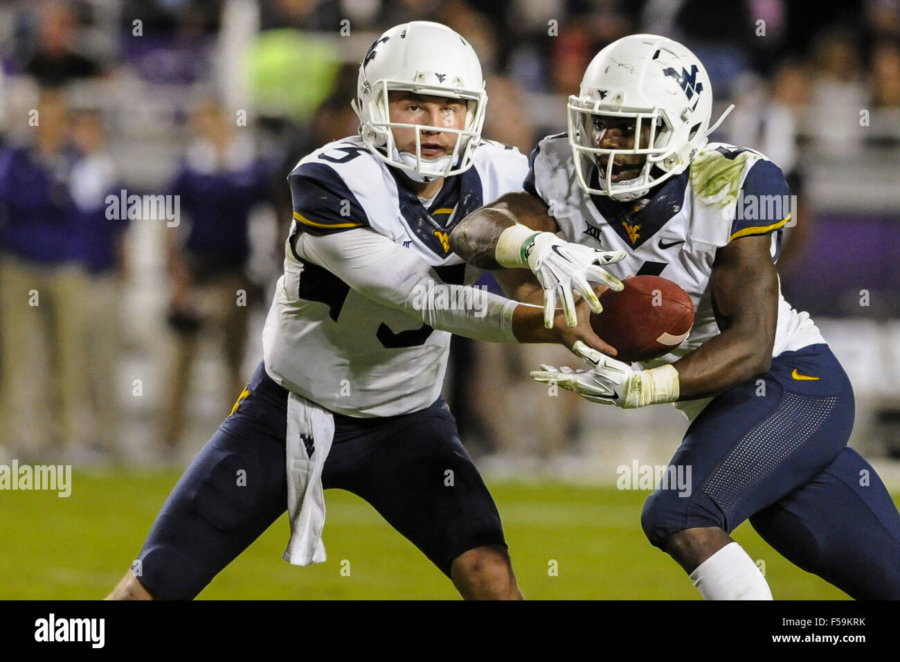 West Virginia quarterback Skyler Howard (3) hands the ball off to ...
