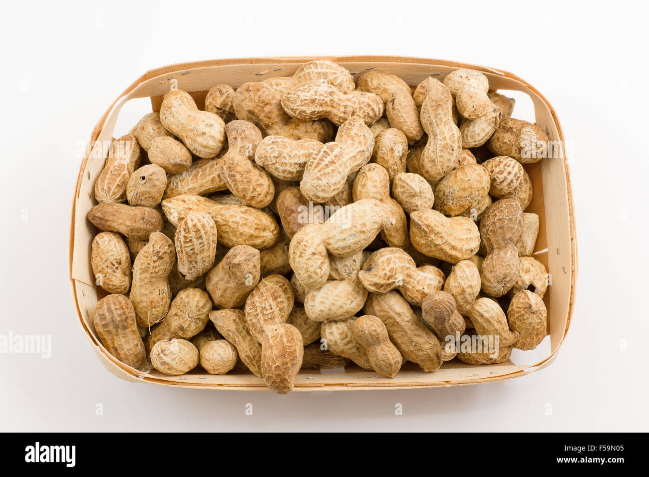 the wooden container is filled with a peanut on a white background ...