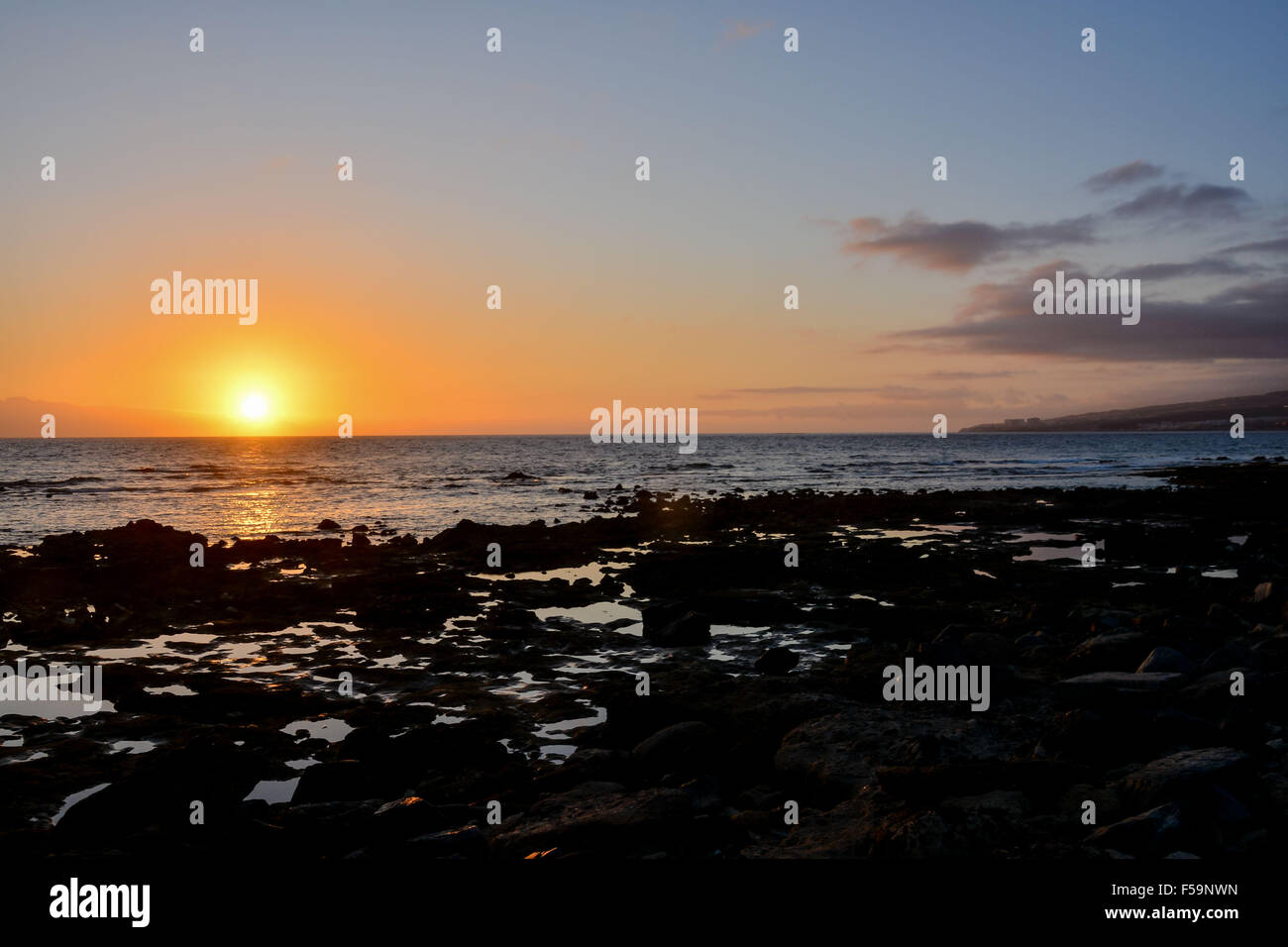 The Sun Setting in the Sea Stock Photo - Alamy