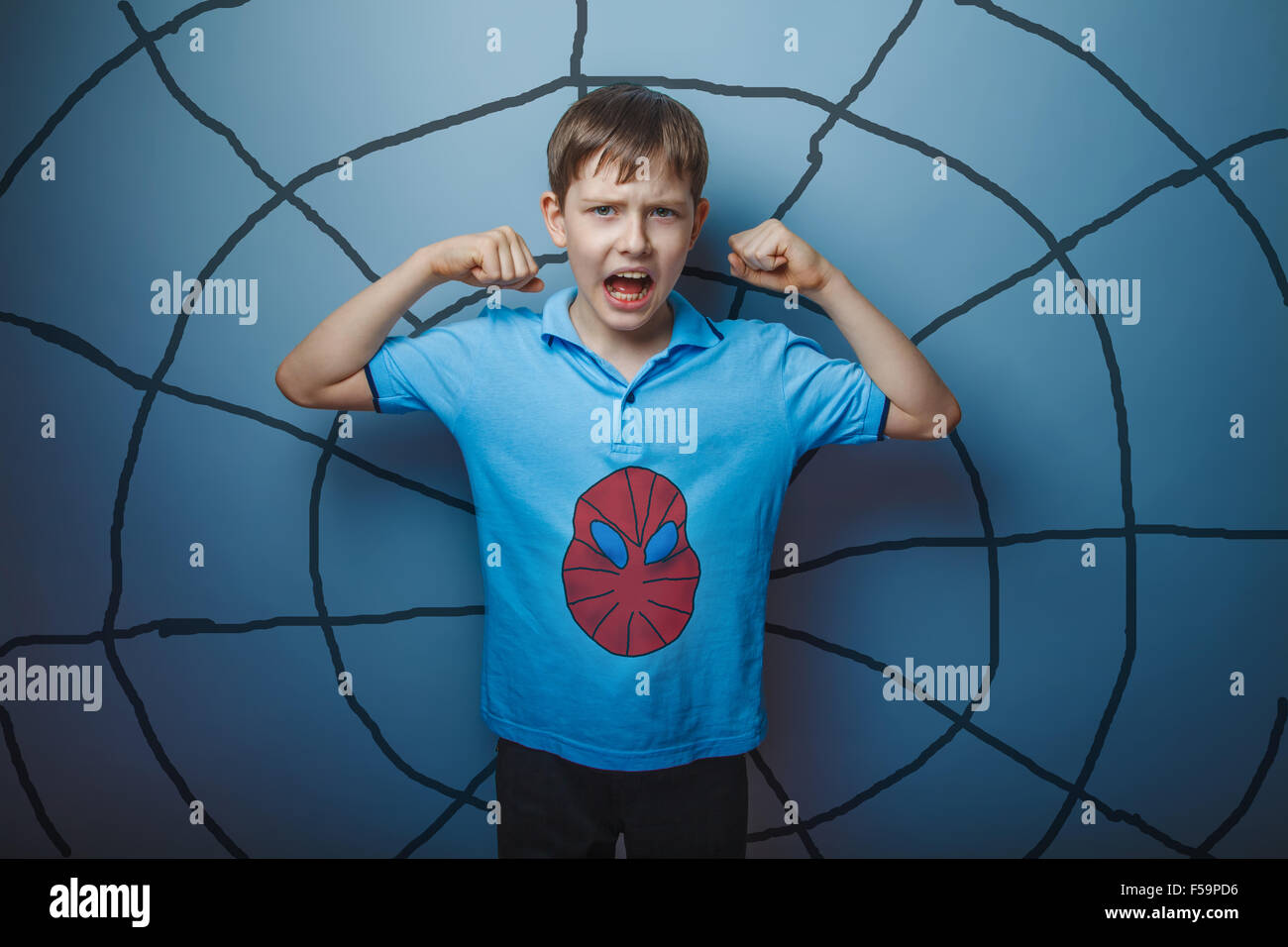 Spider man superhero teen boy raised his arms shouting skin stren Stock ...