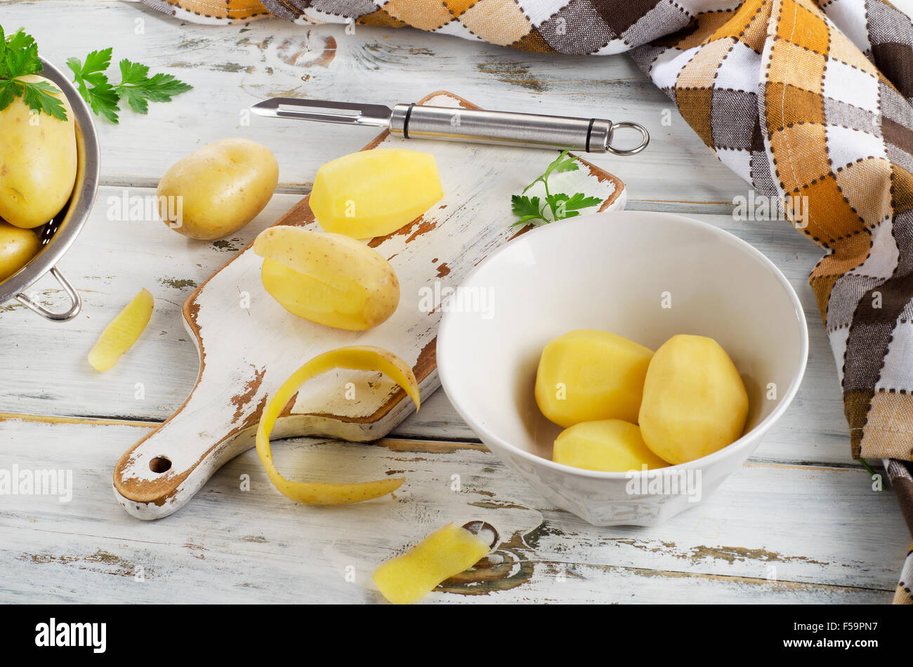 Raw potatoes on a white wooden background. Selective focus Stock Photo ...