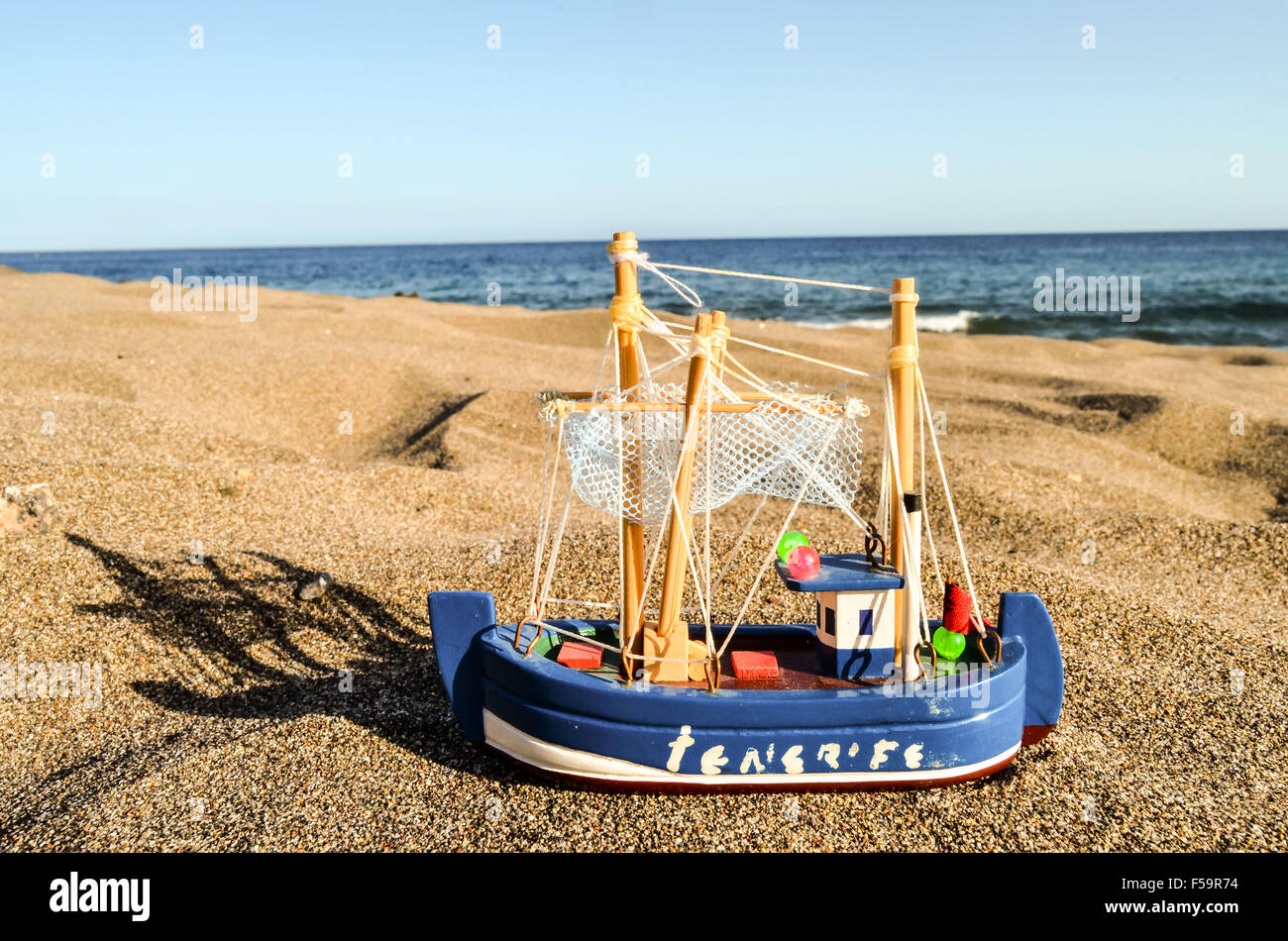 Toy Boat on the Sand Beach Stock Photo - Alamy
