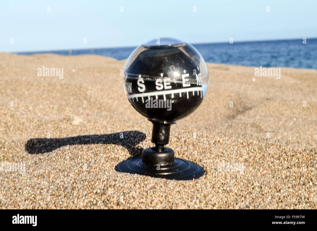 Compass on the Sand Beach Stock Photo - Alamy
