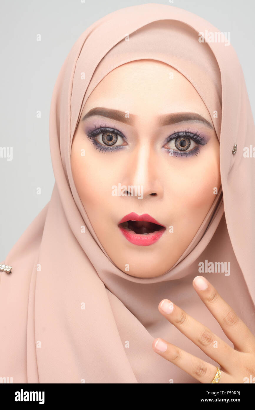Young Asian Muslim Woman With Shock Expression Wearing Hijab Stock