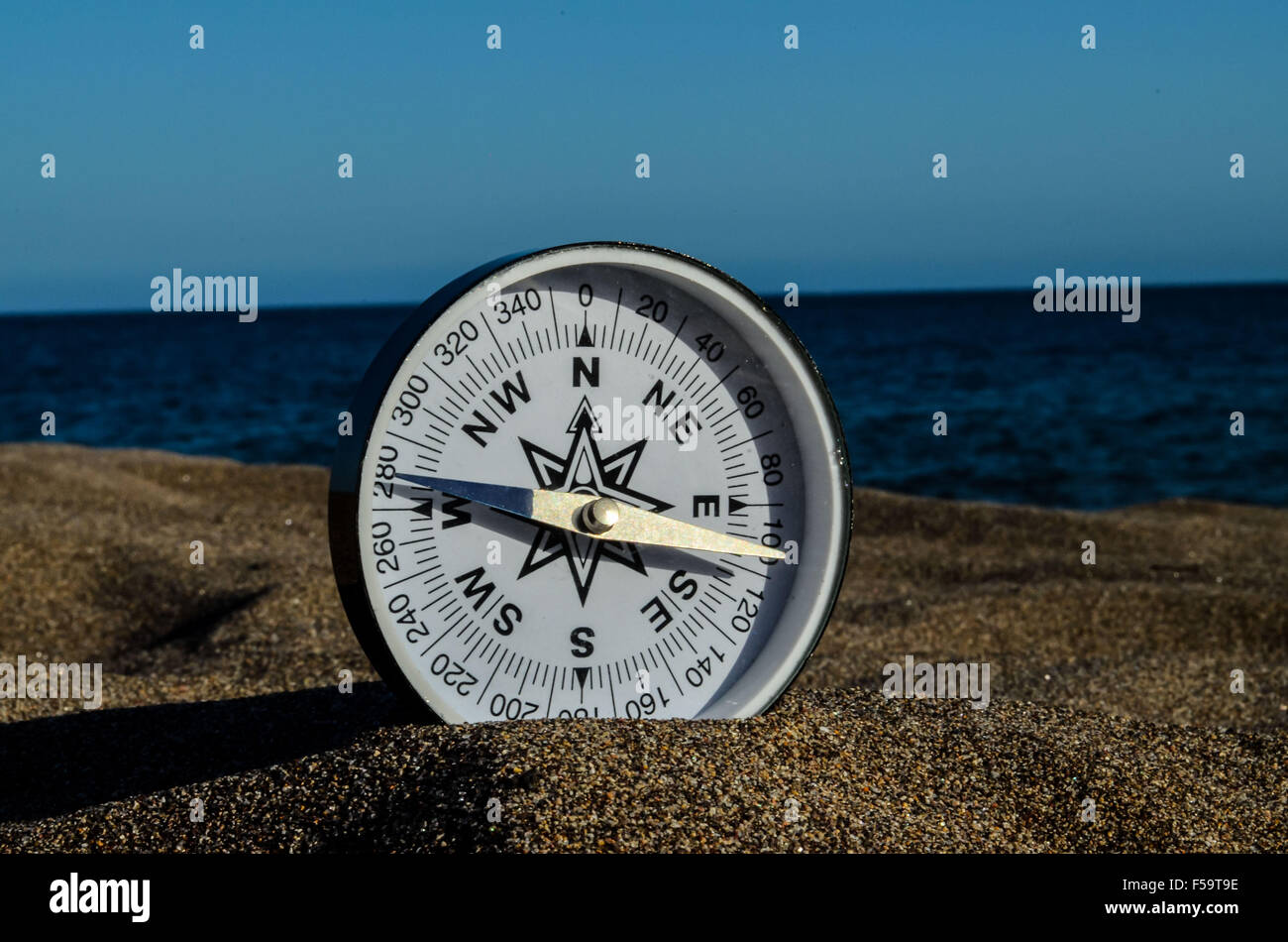 Compass on the Sand Beach Stock Photo - Alamy