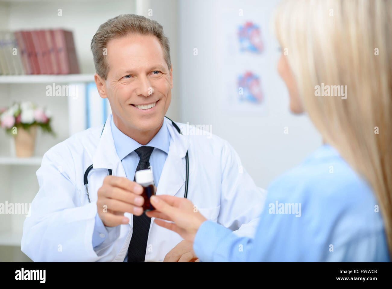 Smiling cardiologist talking to the patient Stock Photo - Alamy