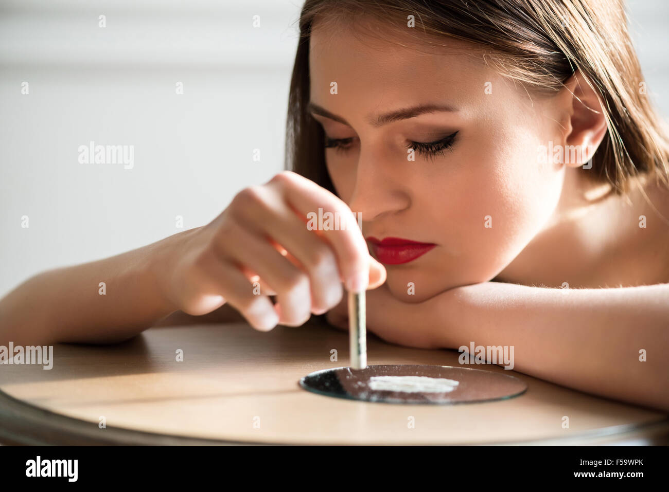 Young girl taking drugs Stock Photo - Alamy