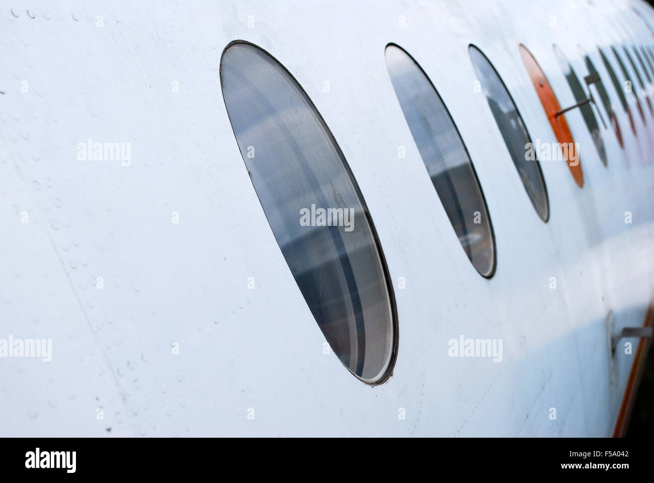 Round windows in side of plane Stock Photo - Alamy