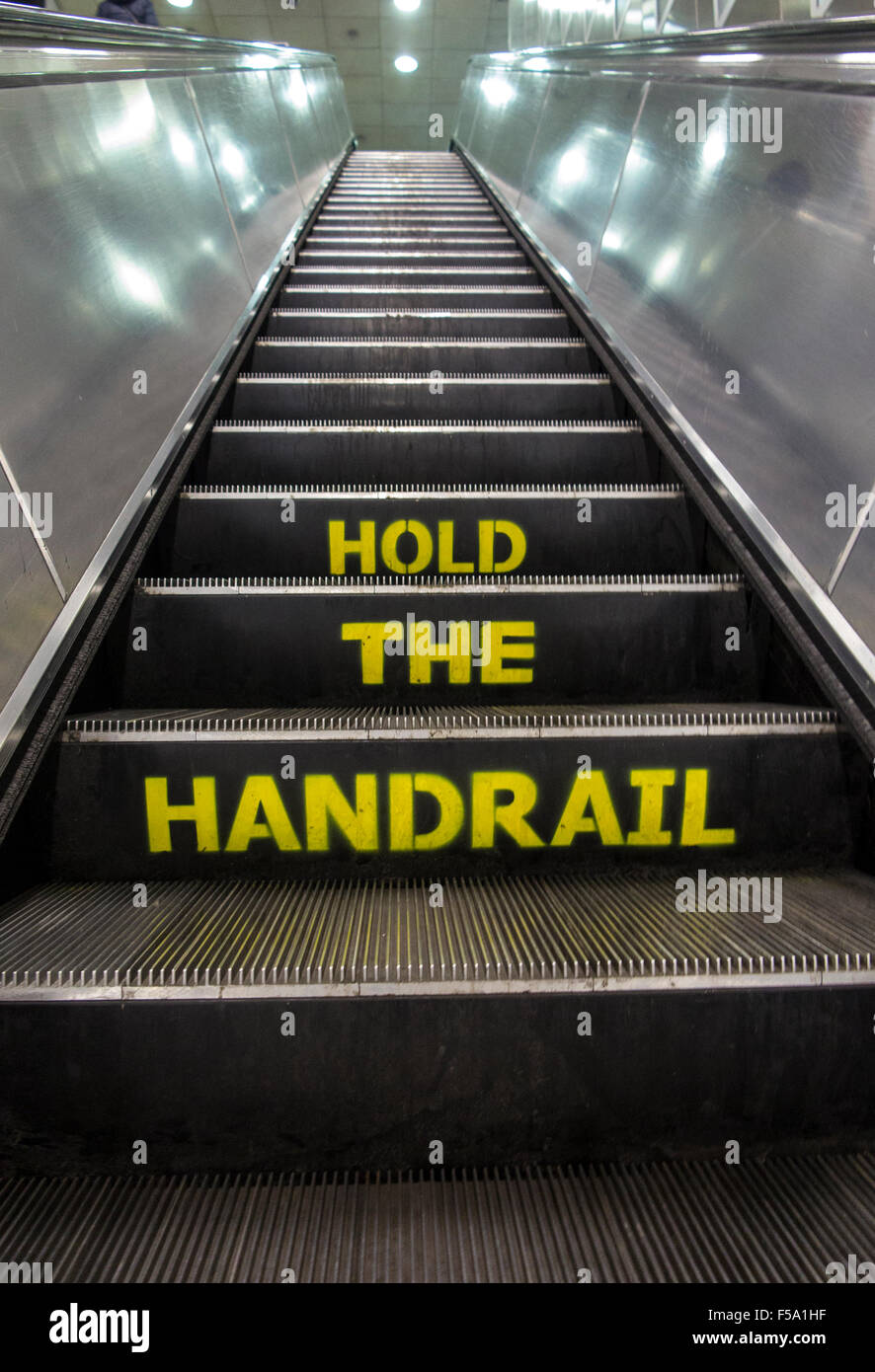 Hold the Handrail notice on an escalator in London Stock Photo - Alamy