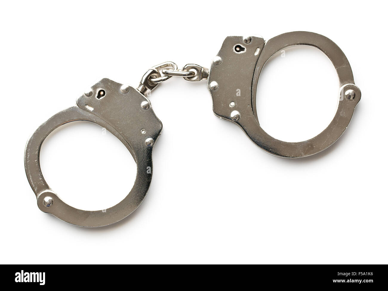 silver handcuffs on white background Stock Photo - Alamy